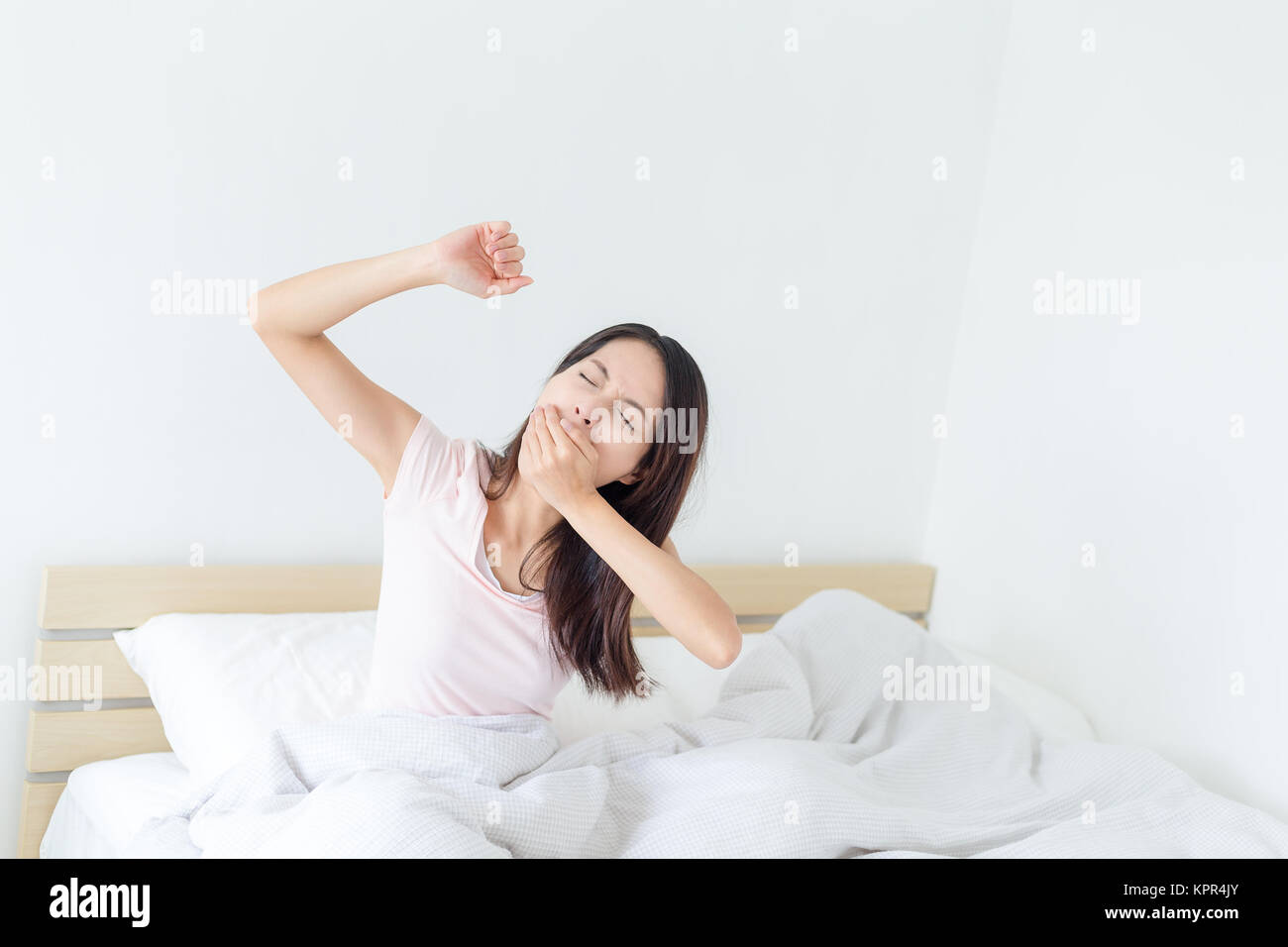 Woman feeling tried at bed Stock Photo - Alamy