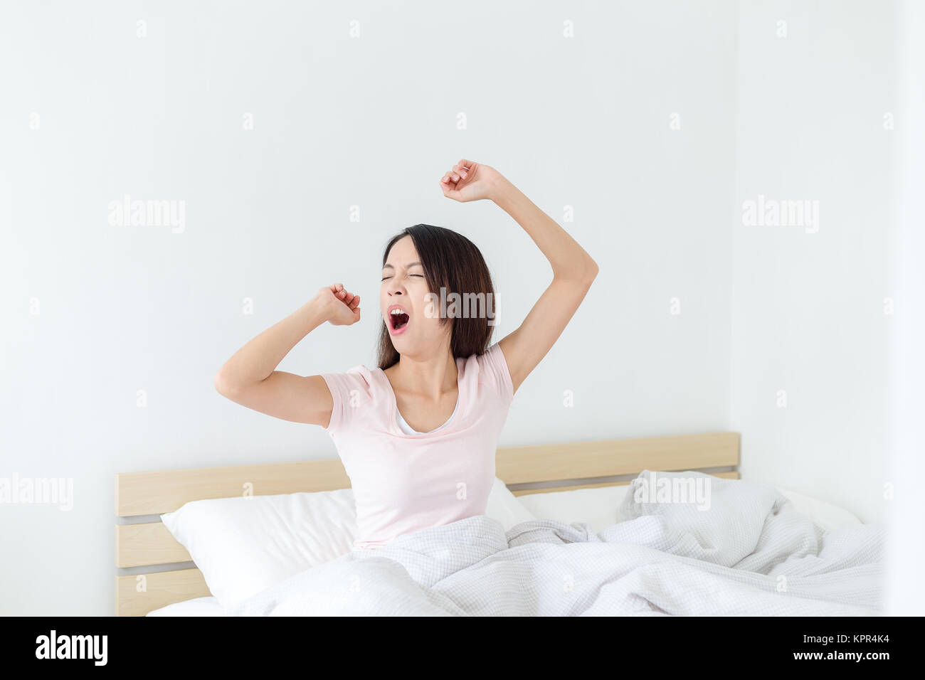 Woman wake up at morning and hand stretching Stock Photo - Alamy