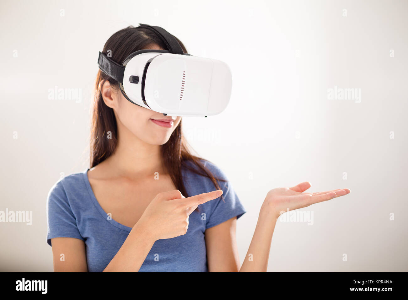 Woman using virtual reality and hand showing copy space Stock Photo - Alamy