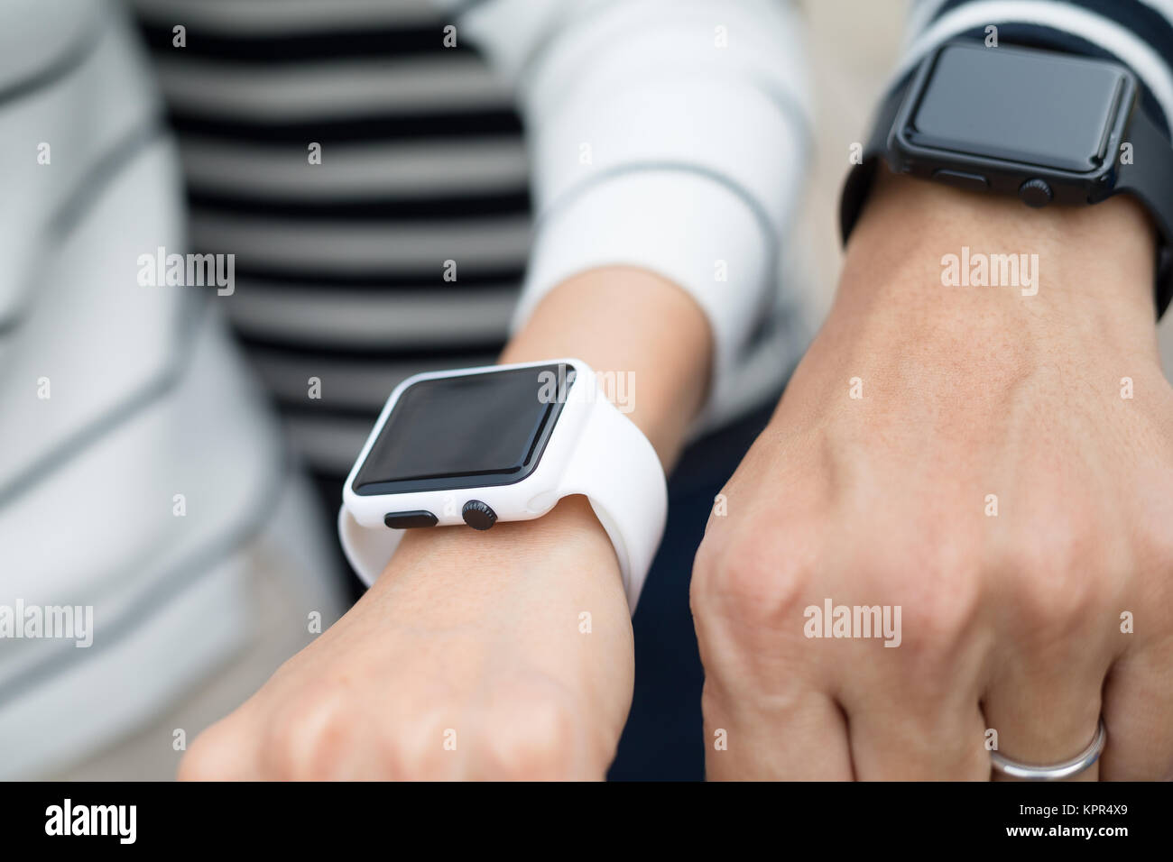 Couple using smart watch together Stock Photo - Alamy