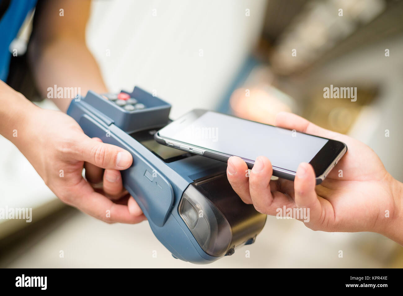 Customer using cellphone for pay by NFC technology Stock Photo - Alamy