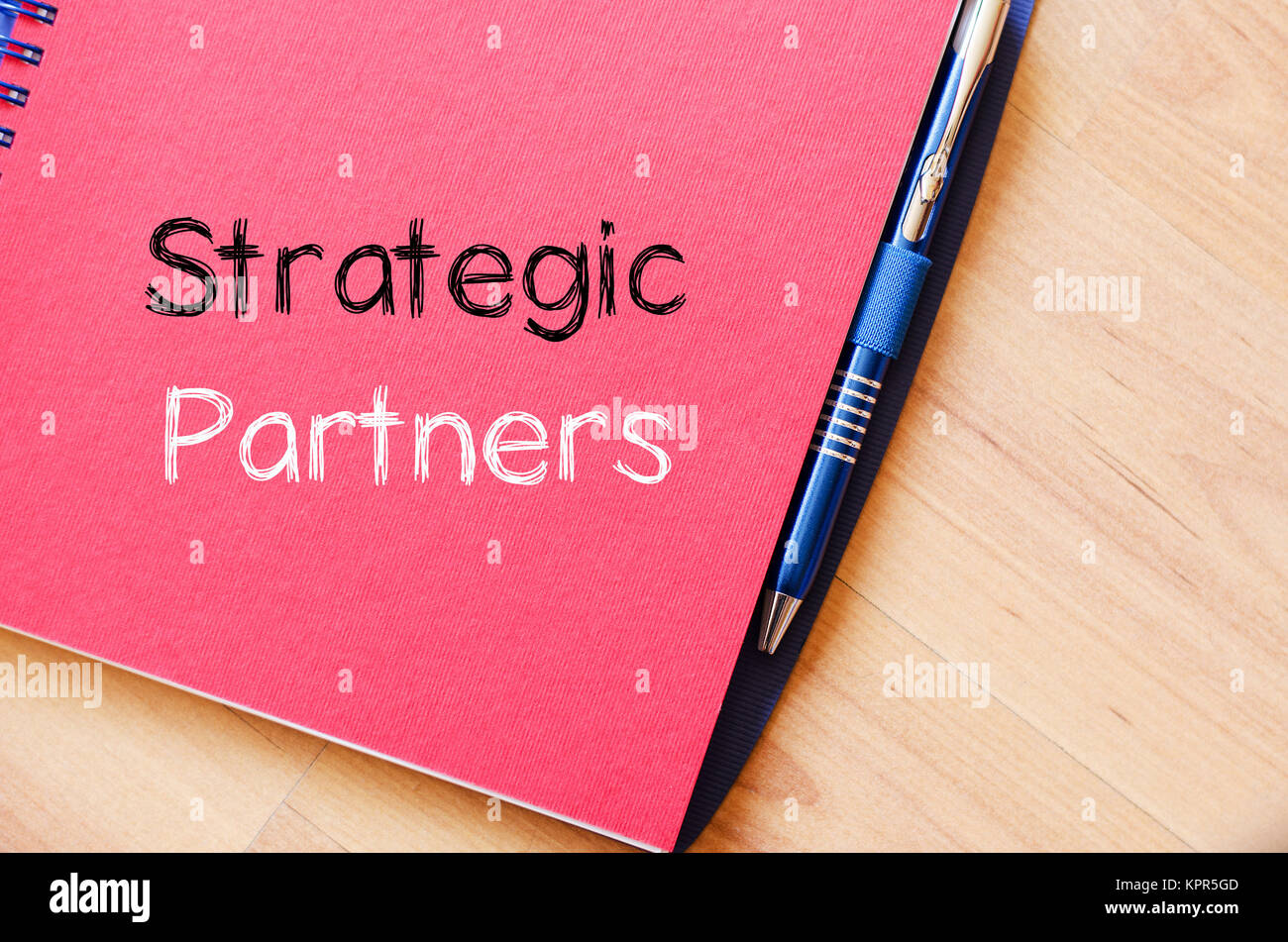Strategic partners write on notebook Stock Photo - Alamy