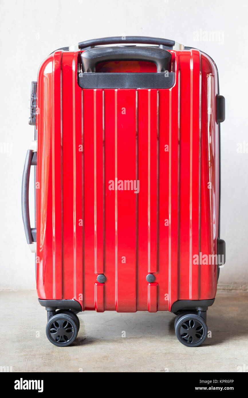 Red travel suitcase for outgoing Stock Photo - Alamy
