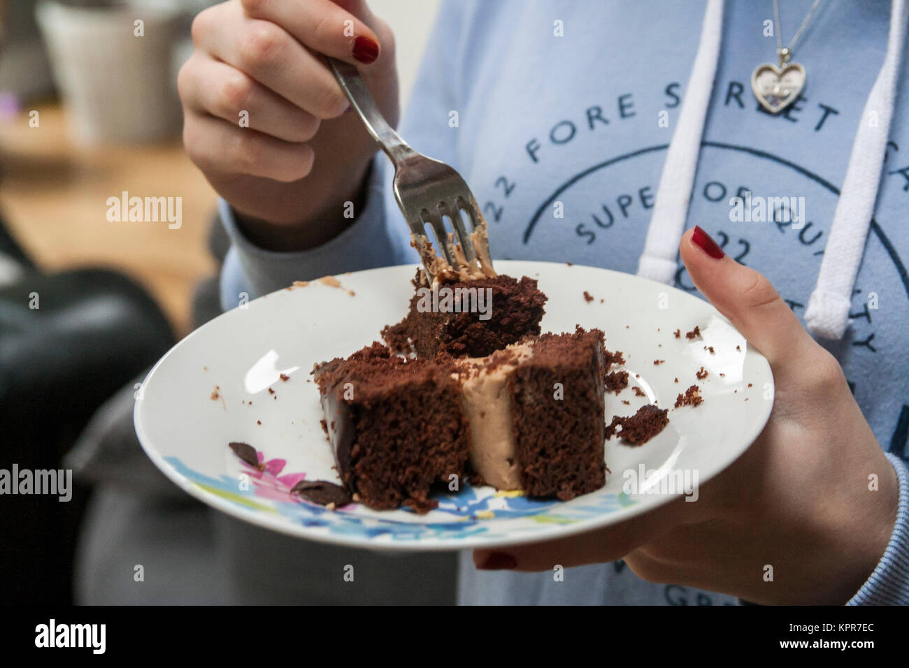 Hand holding a fork about to eat a piece of chocolate cake Stock Photo ...