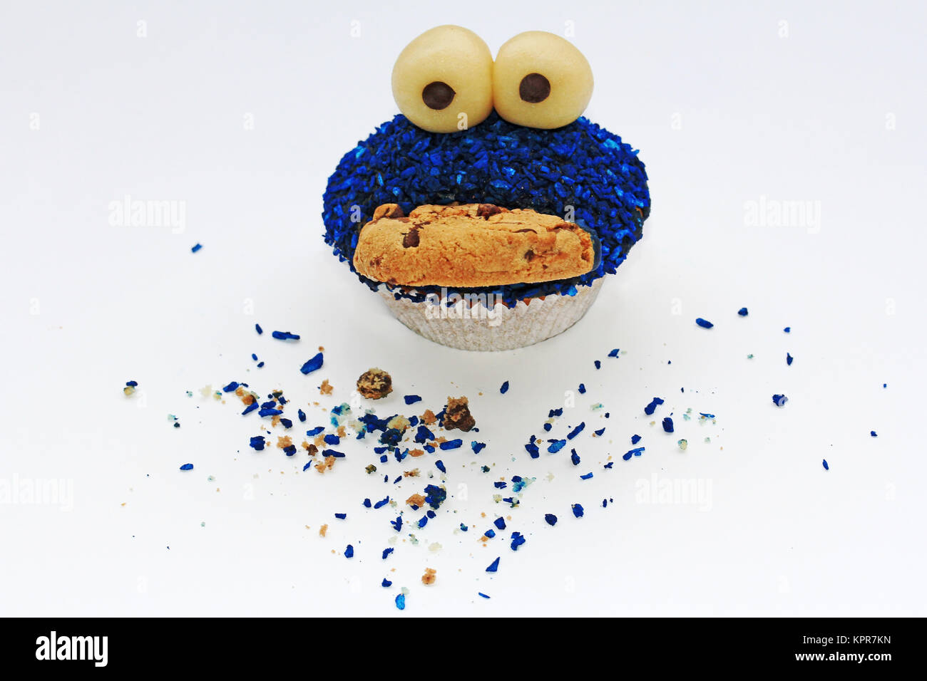 A funny muffin with eyes,mouth and blue sugar sprinkles Stock Photo - Alamy