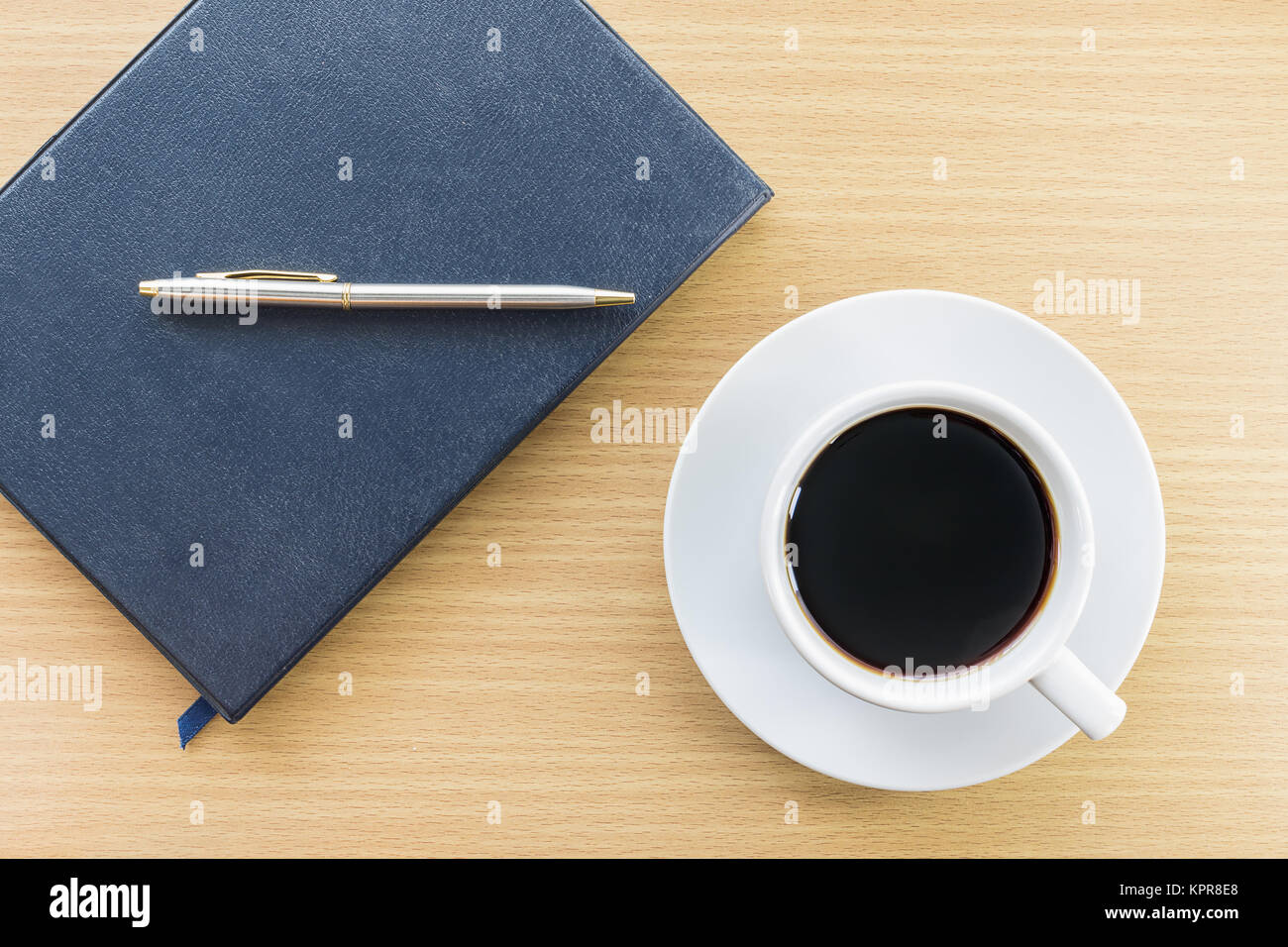 Coffee and notebook on wood table Stock Photo - Alamy
