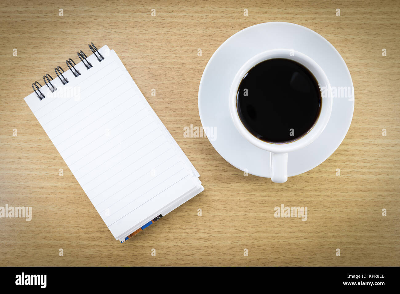 Coffee and notepad on wood table Stock Photo - Alamy