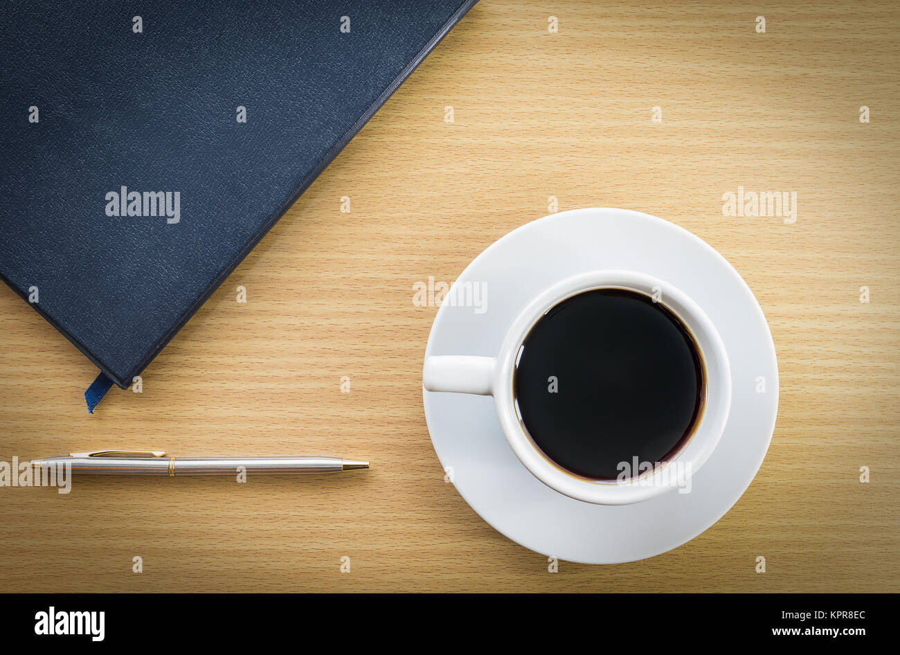Coffee cup and notebook Stock Photo - Alamy