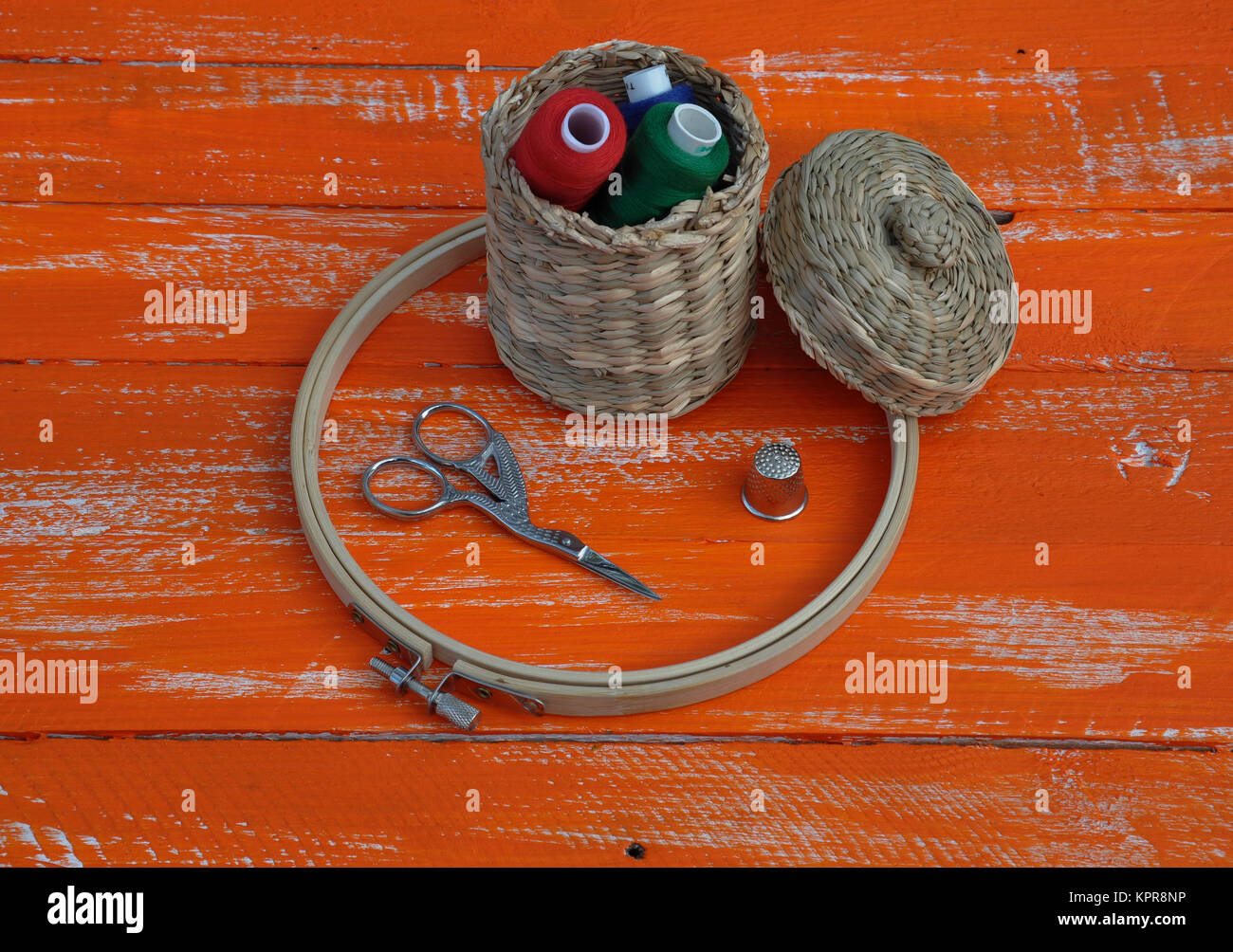 Spools of thread in a wicker basket and items for needlework Stock ...