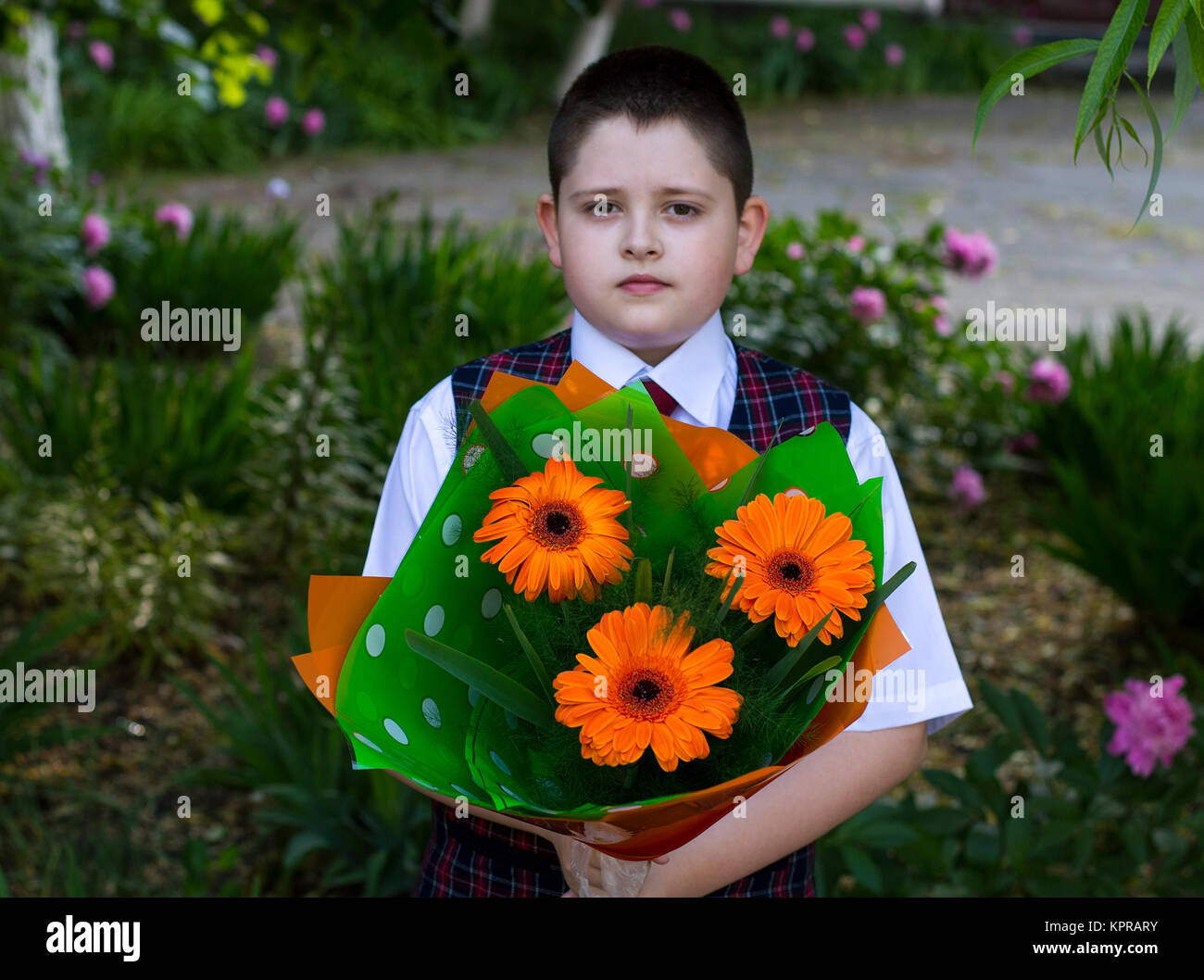 the school student with a beautiful bouquet of flowers, the front view ...