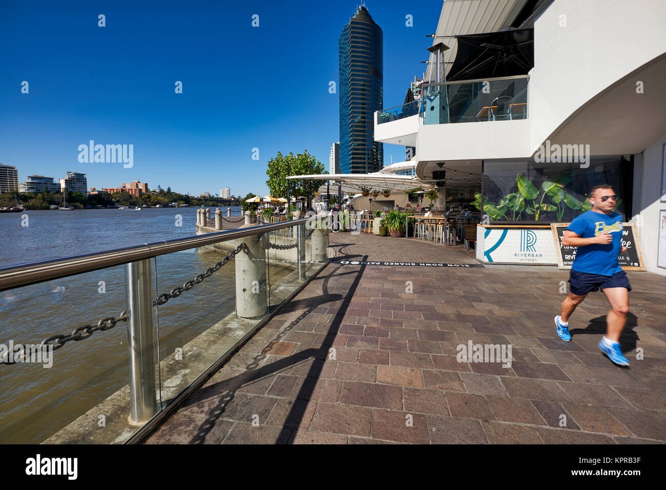 Modern high-rise buildings at Eagle Street Pier beside river in ...