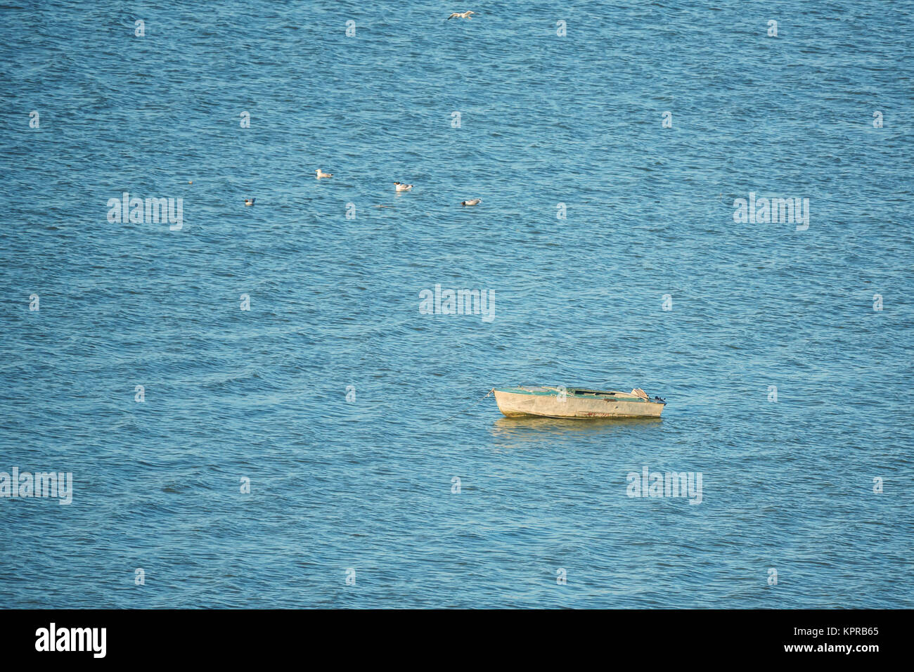 Small old fishing boat floats on water Stock Photo - Alamy