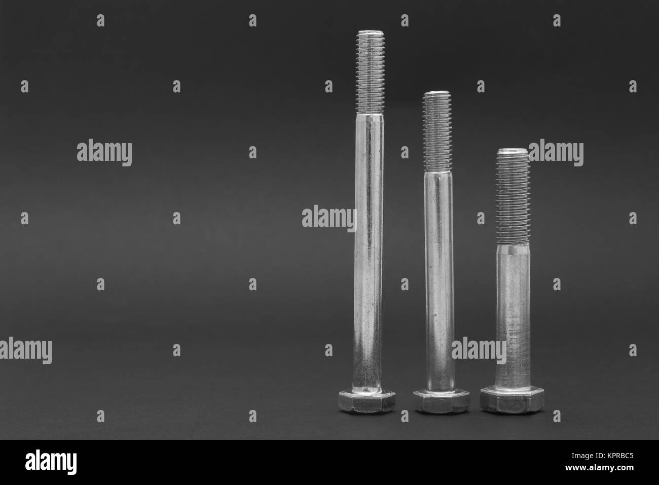 Various Isolated bolts on a dark background Stock Photo - Alamy