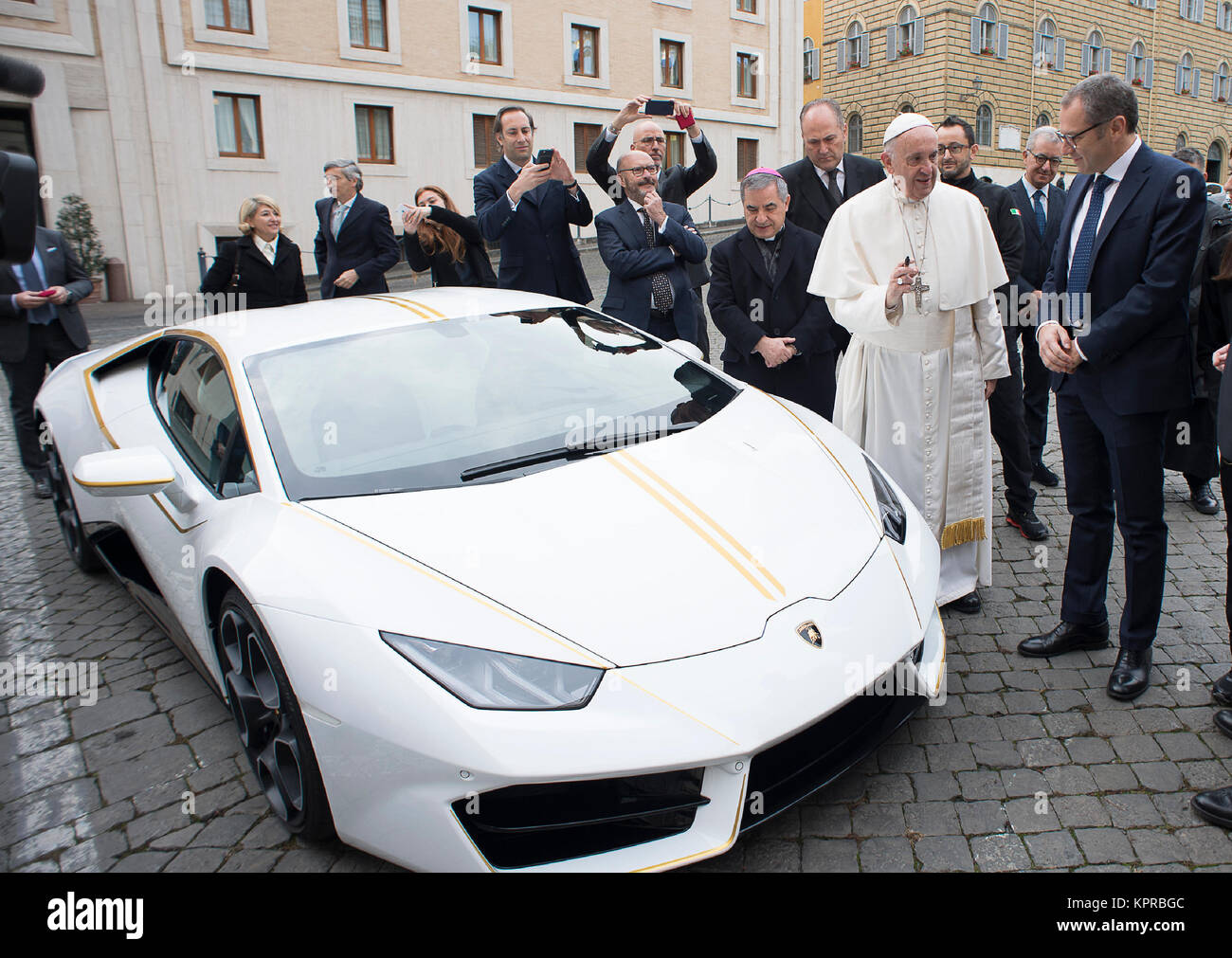Pope Francis writes on the bonnet of a Lamborghini donated to him by ...