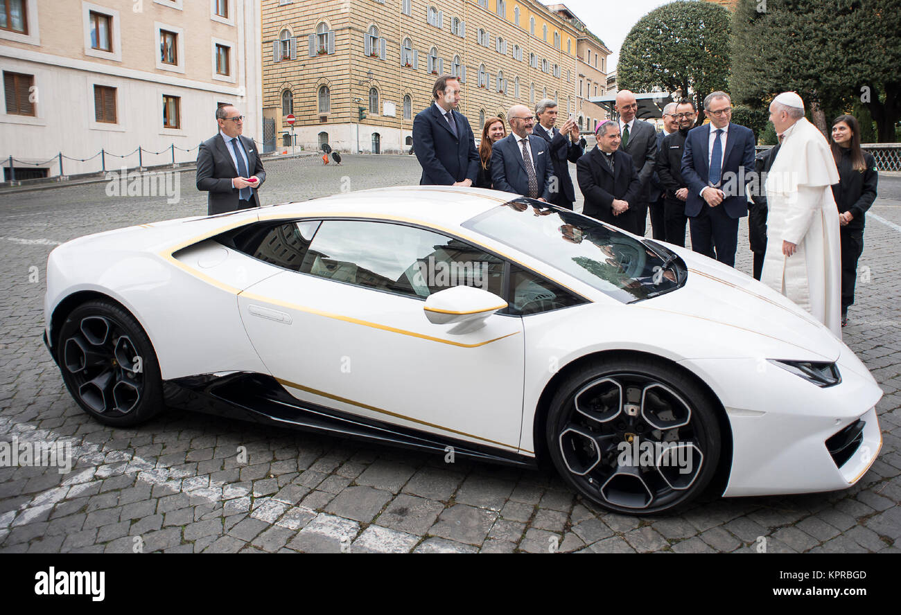 Pope Francis writes on the bonnet of a Lamborghini donated to him by ...