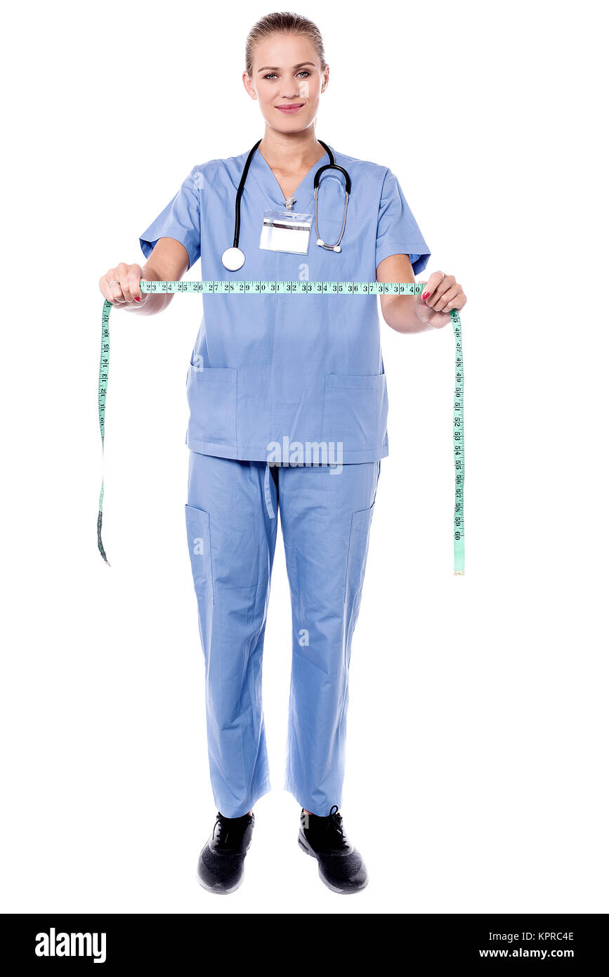Female physician holding measuring tape Stock Photo - Alamy