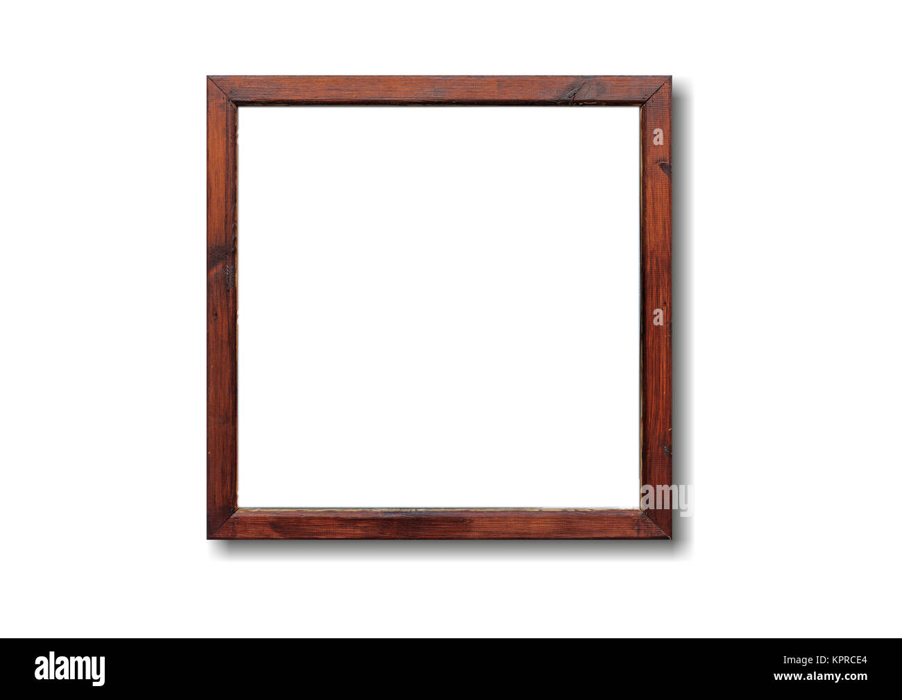 Empty wooden frame on the wall. White inside and background, space for ...