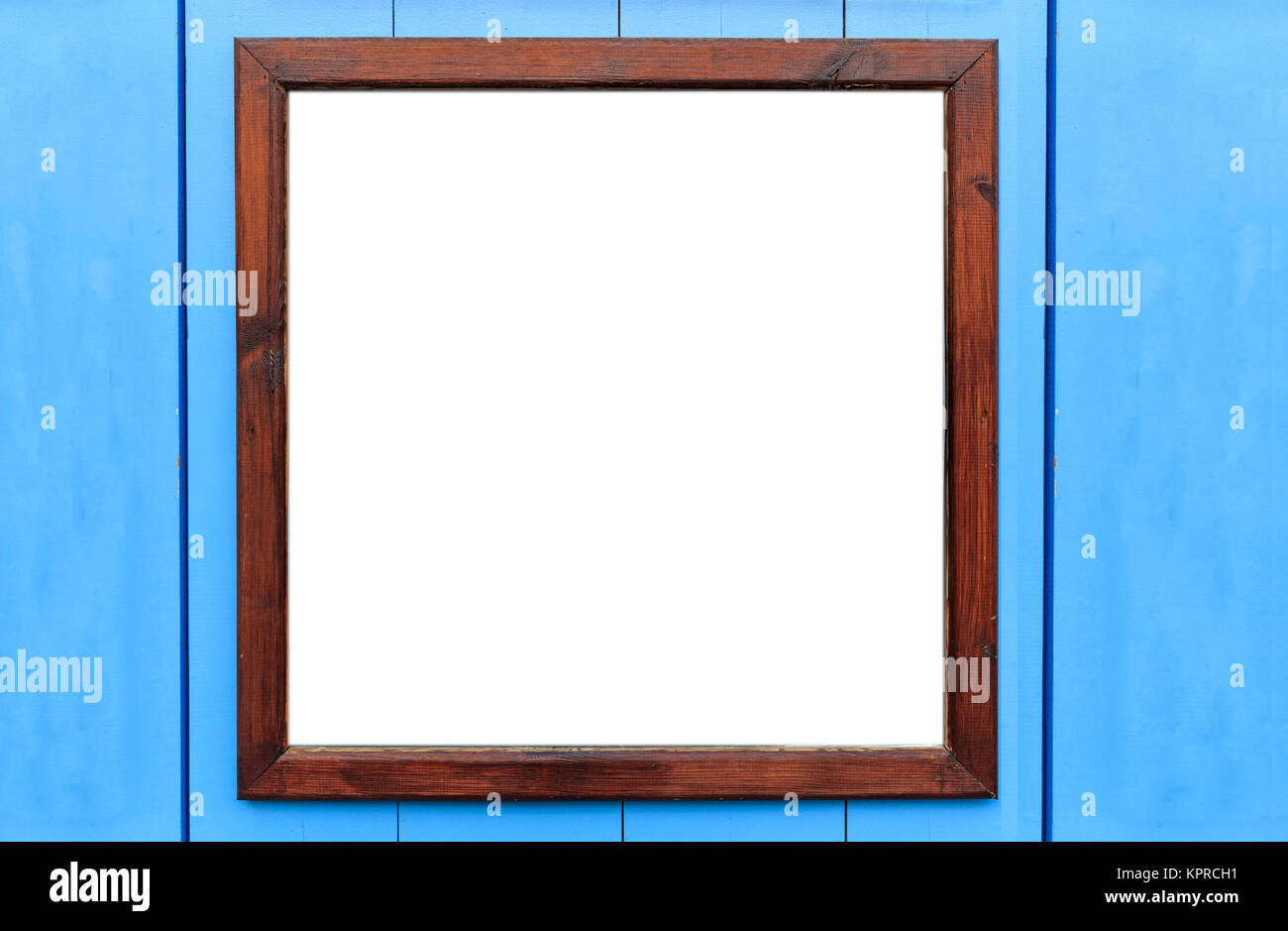 Blank wooden frame on the wall. White inside and light blue background ...
