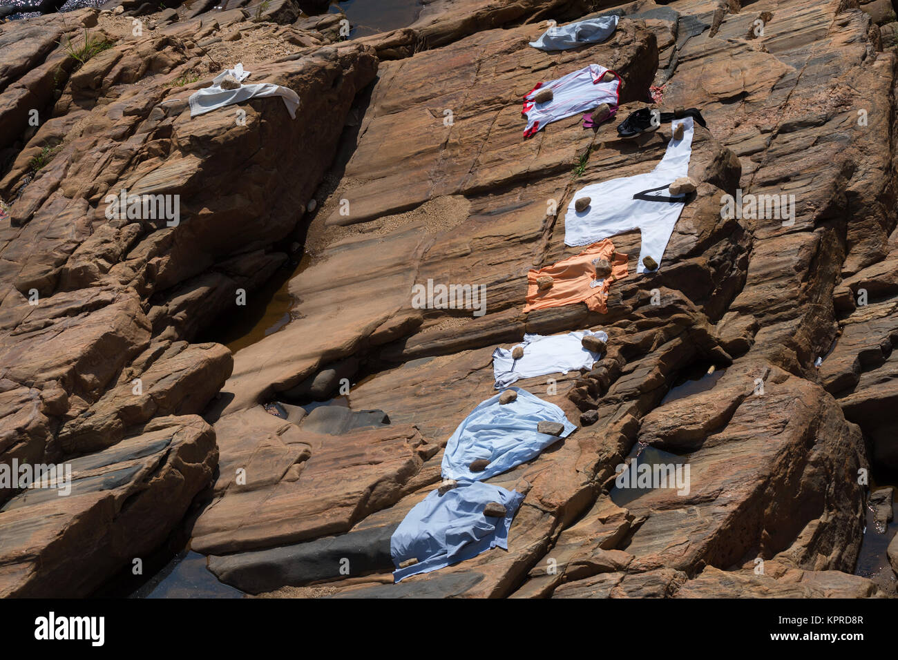 Wash clothes on rock hi-res stock photography and images - Alamy