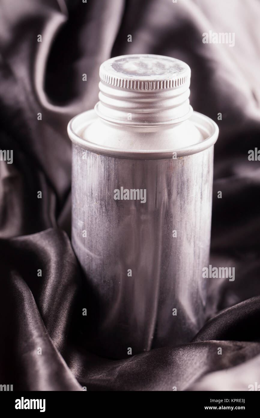 Metal bottle over black background Stock Photo - Alamy