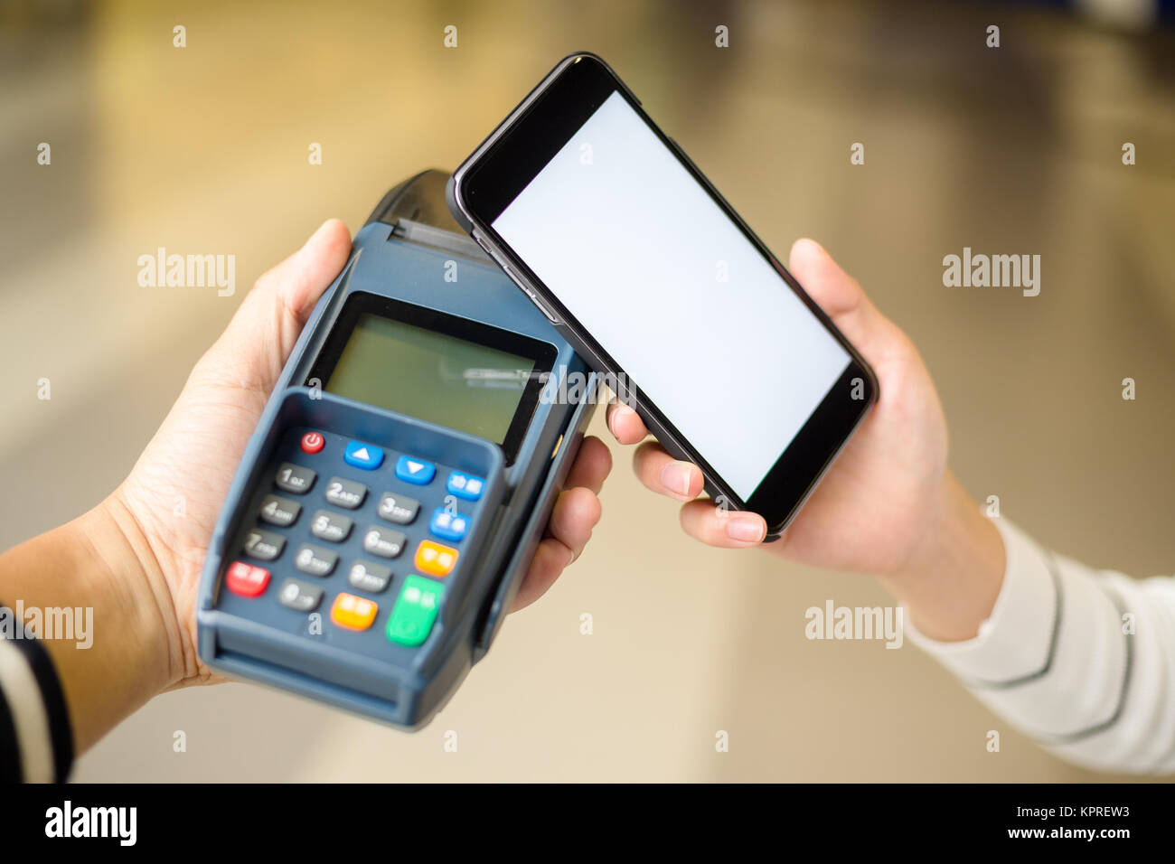 Customer pay with cellphone Stock Photo - Alamy
