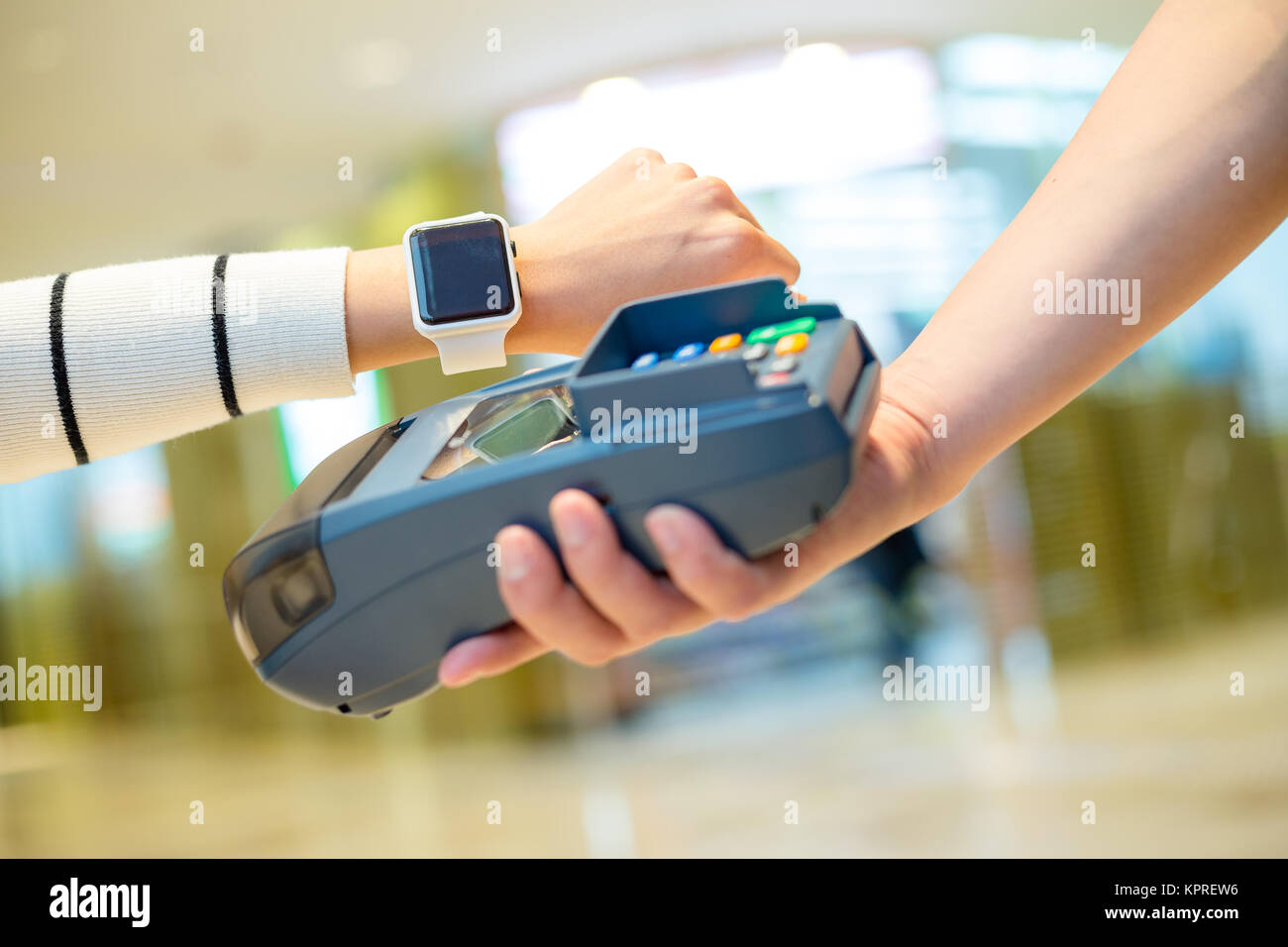 Woman pay on pos machines with smart watch Stock Photo - Alamy