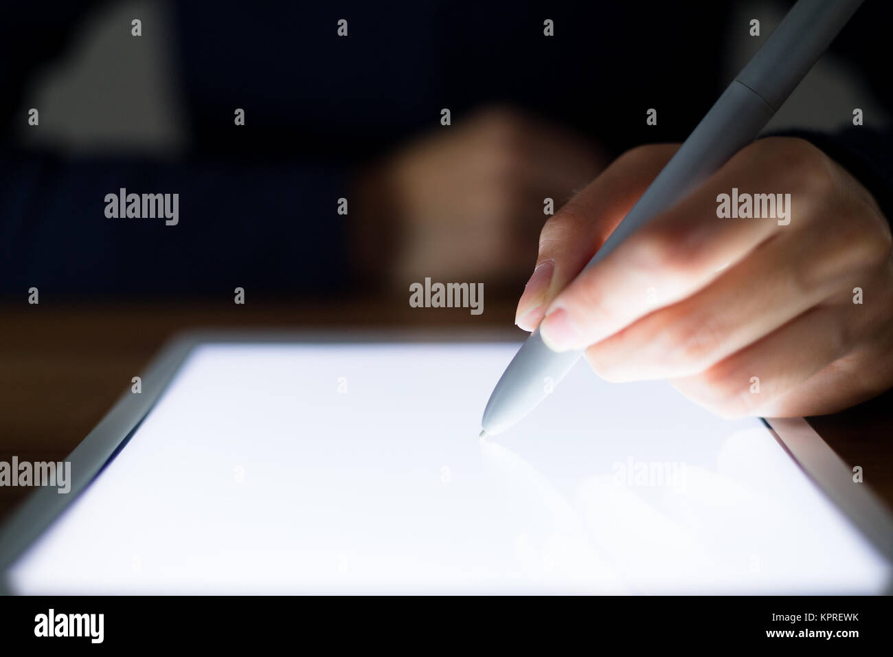 Woman writing something on digital tablet Stock Photo - Alamy