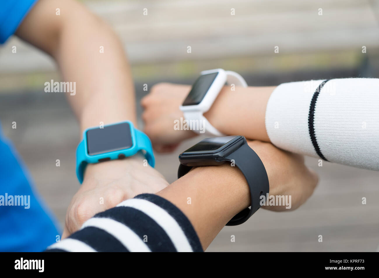 Friends using smart watch together Stock Photo - Alamy