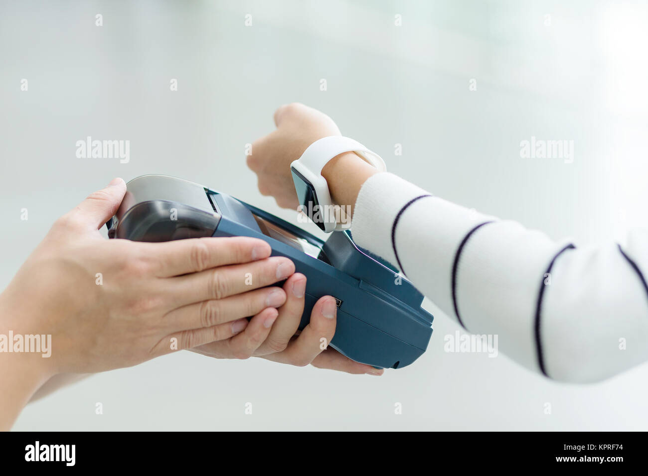 Woman using smart watch to pay Stock Photo - Alamy