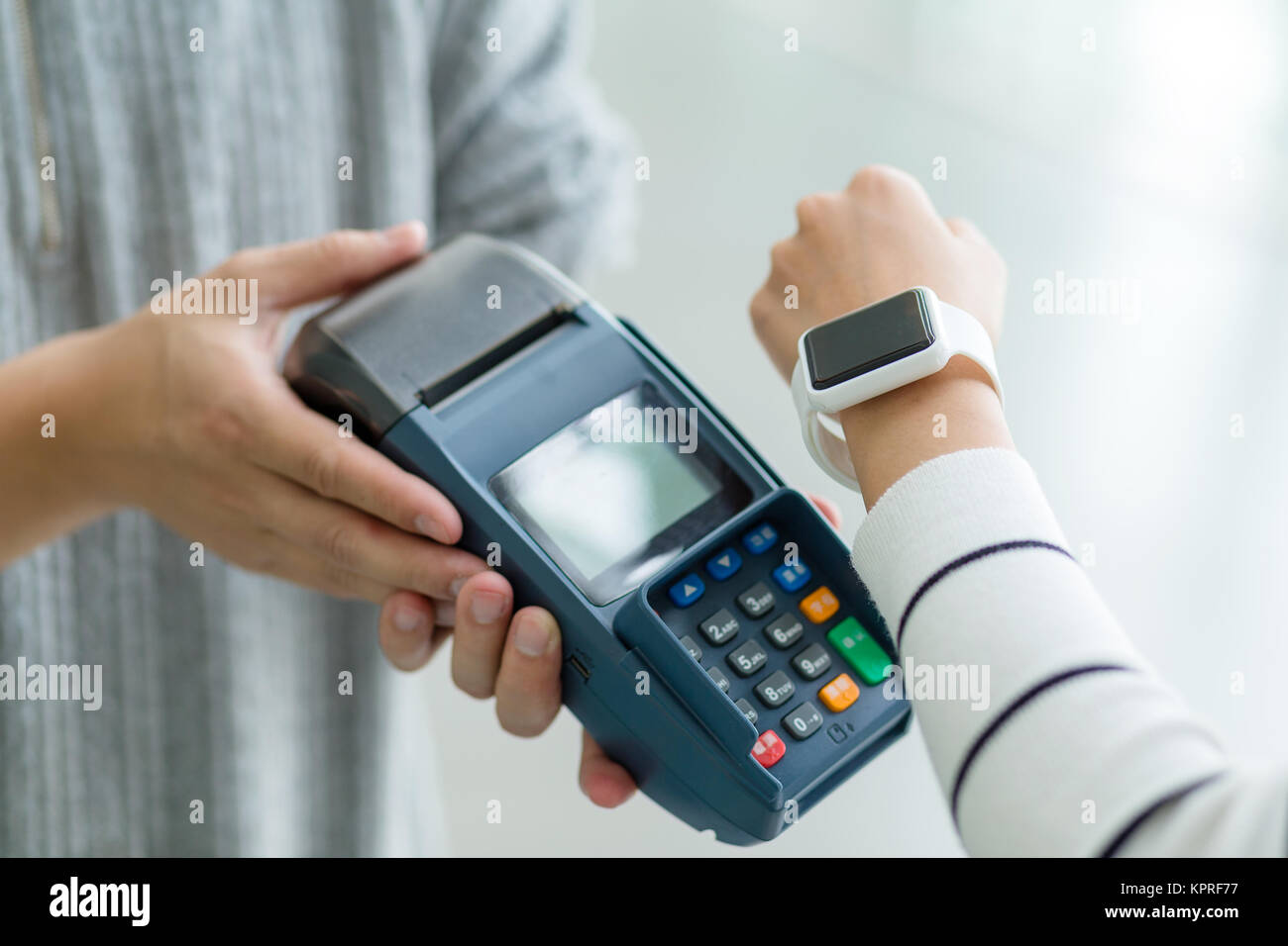 Woman using smart watch to pay Stock Photo - Alamy