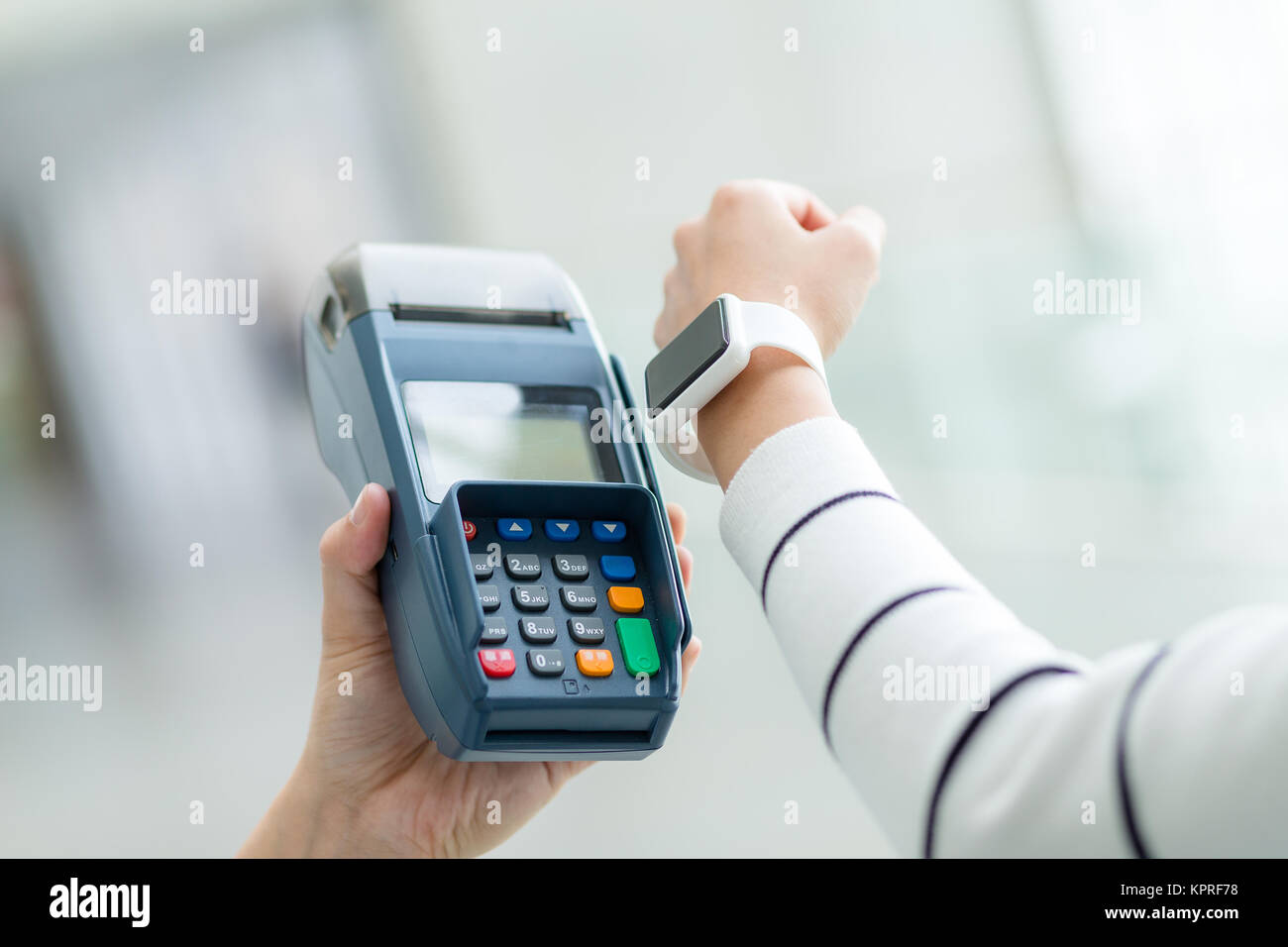 Customer using smart watch for payment Stock Photo - Alamy