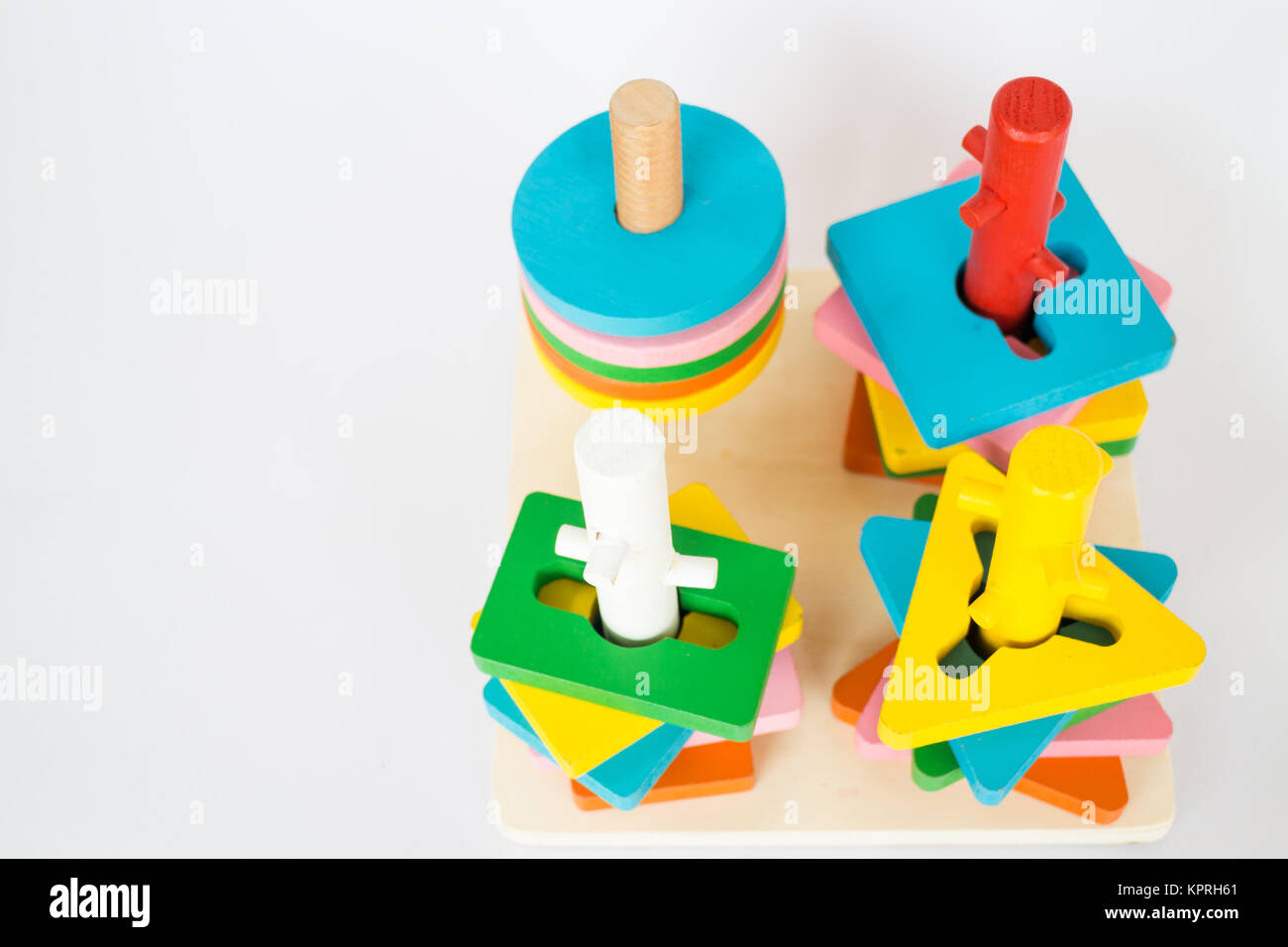 Colorful puzzle wooden toy on white table Stock Photo - Alamy
