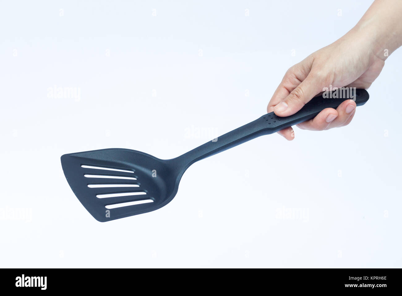 Black plastic kitchen spatula on white background Stock Photo - Alamy