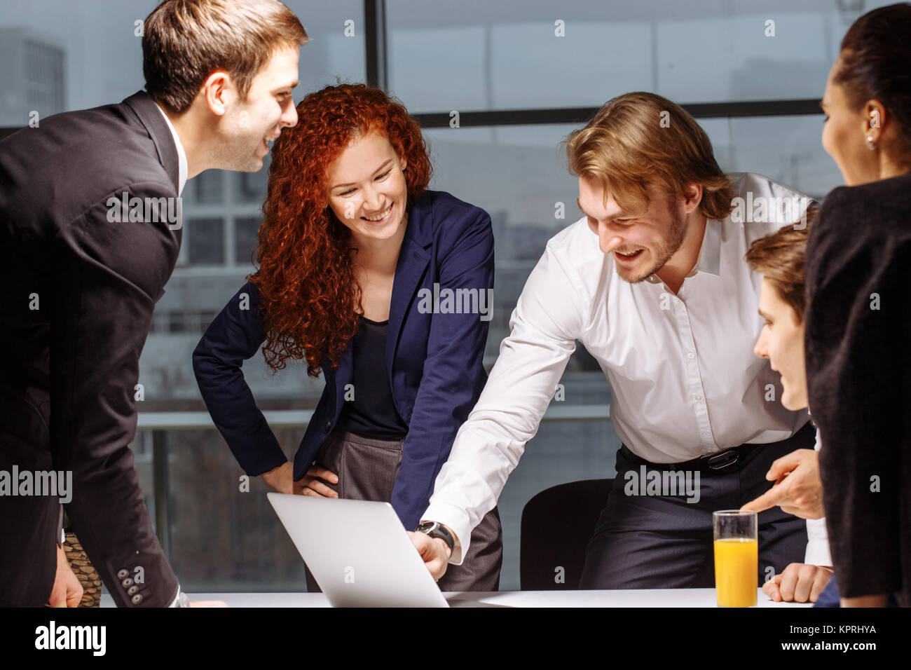 male and female business people around laptop computer in office Stock ...