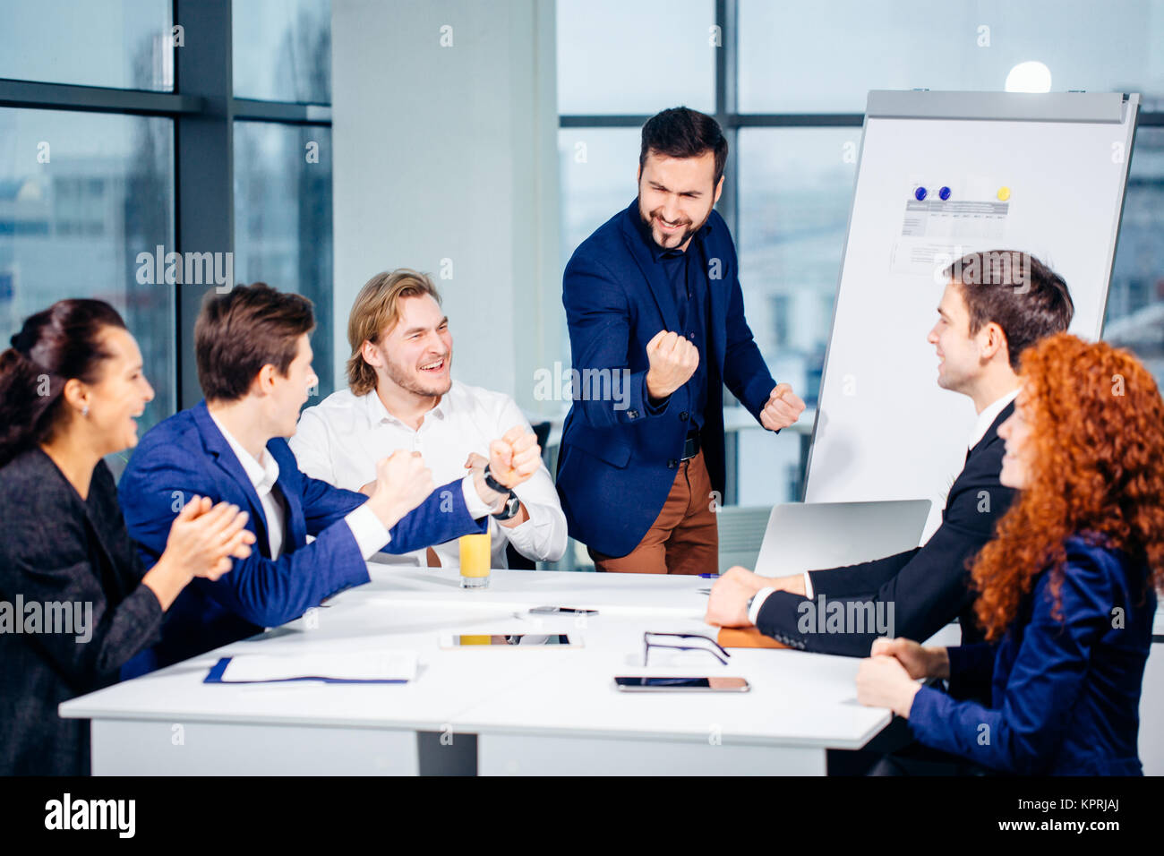 smiling male boss talking to business group Stock Photo - Alamy