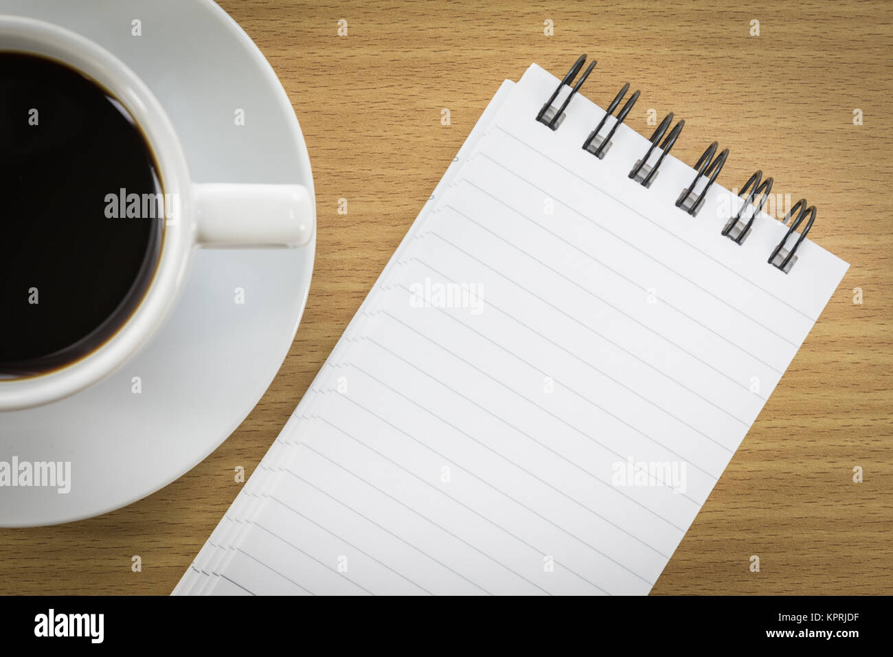 Coffee and notepad on wood table Stock Photo - Alamy