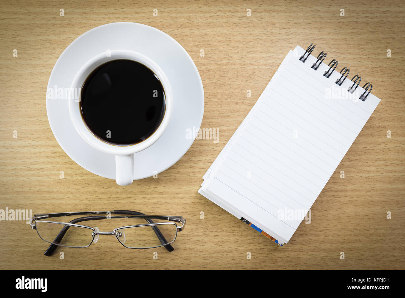 Coffee and notepad on wood table Stock Photo - Alamy