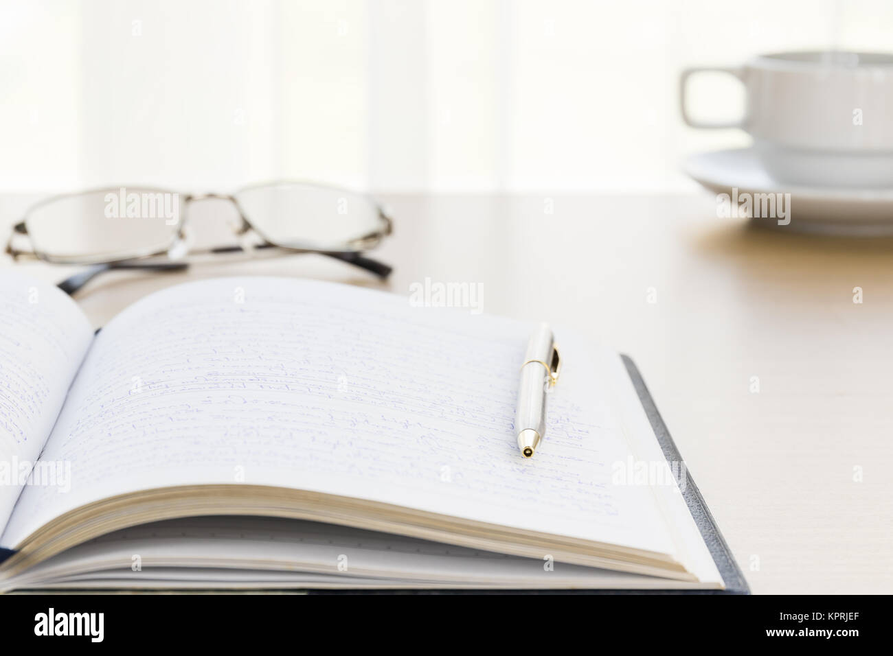 Pen put on a book with on the desk Stock Photo - Alamy