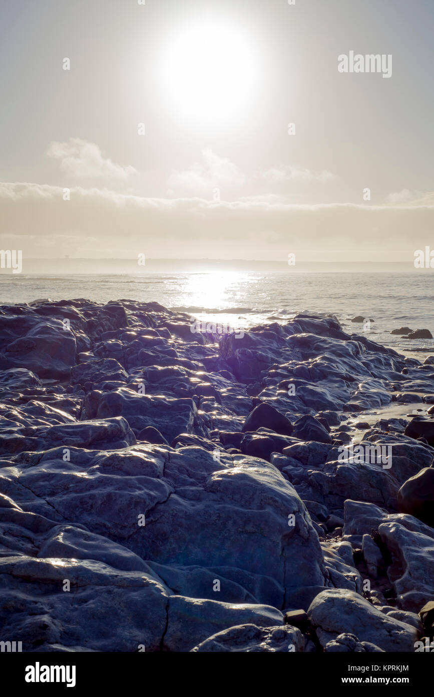 waves over white sunset rocks Stock Photo - Alamy