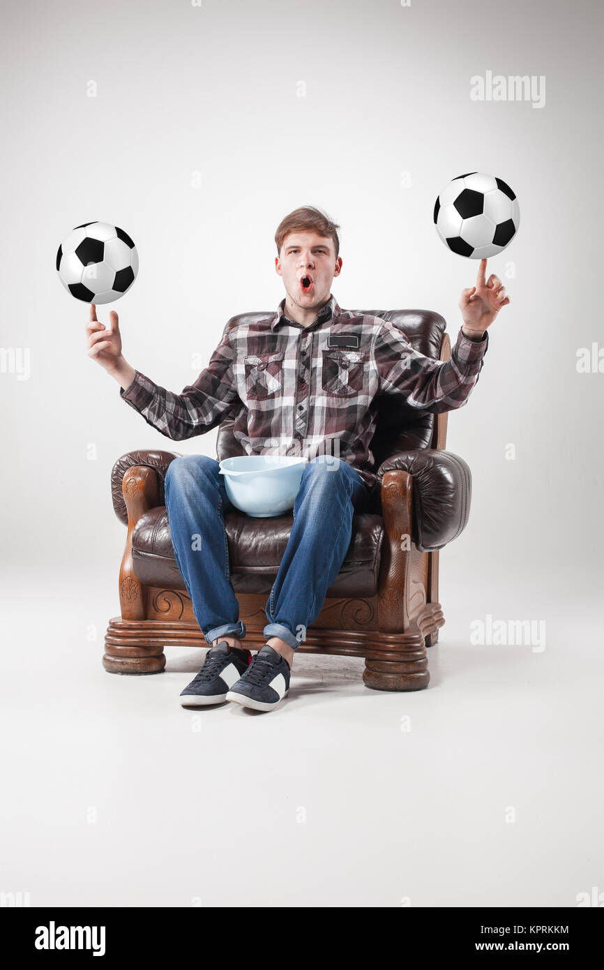 The portrait of fan with balls, holding dish on gray background Stock ...