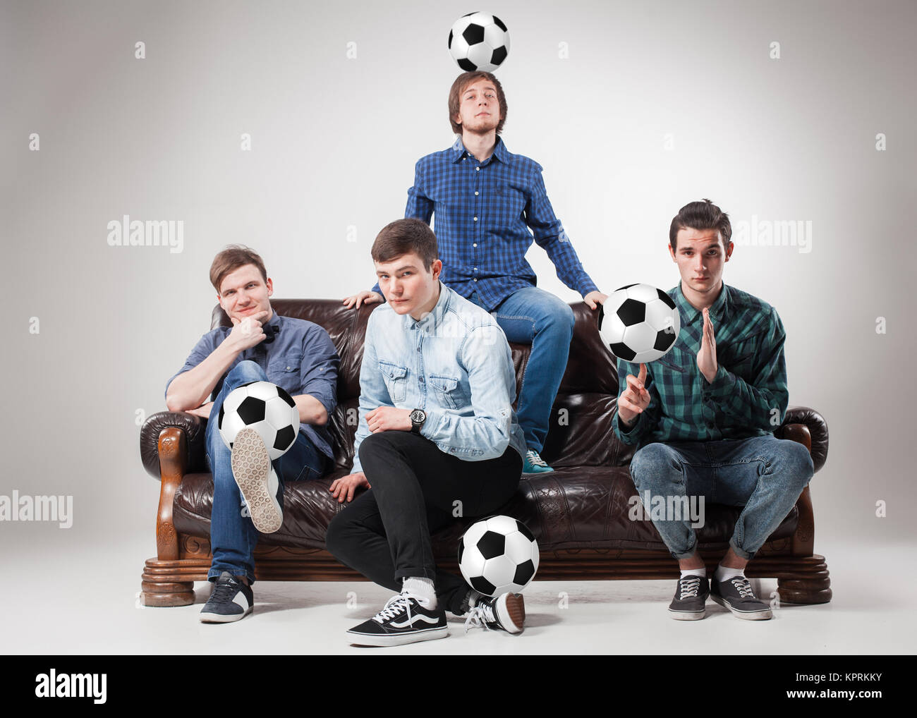 The four guys with balls on gray background Stock Photo - Alamy