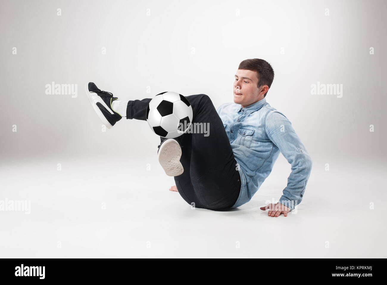 The portrait of fan with ball on gray background Stock Photo - Alamy