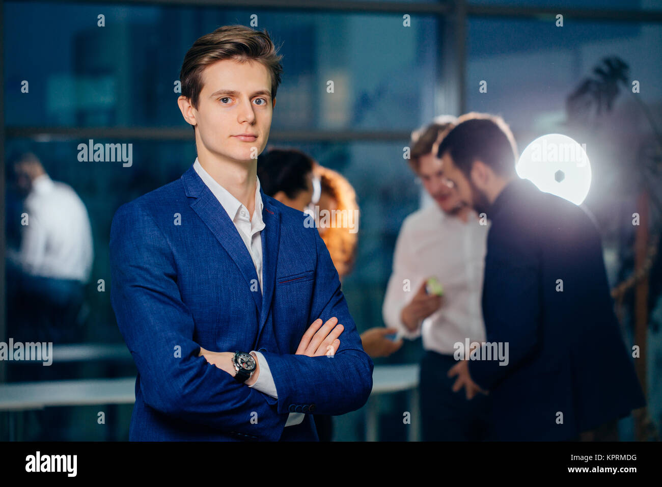 beautiful man on background of business people Stock Photo - Alamy
