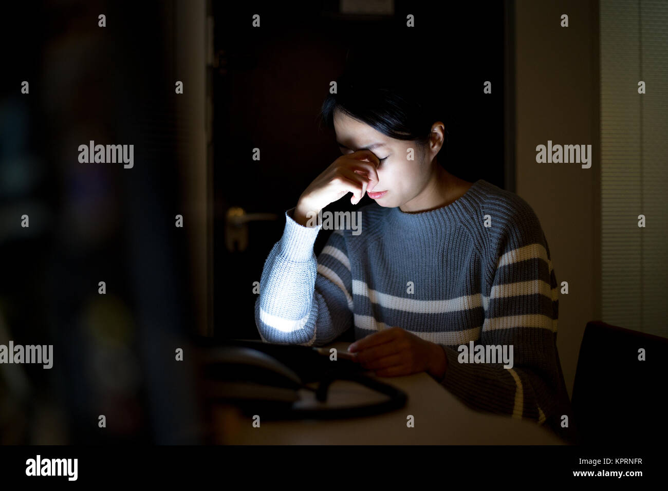 Woman feeling eye pain when using digital tablet Stock Photo - Alamy