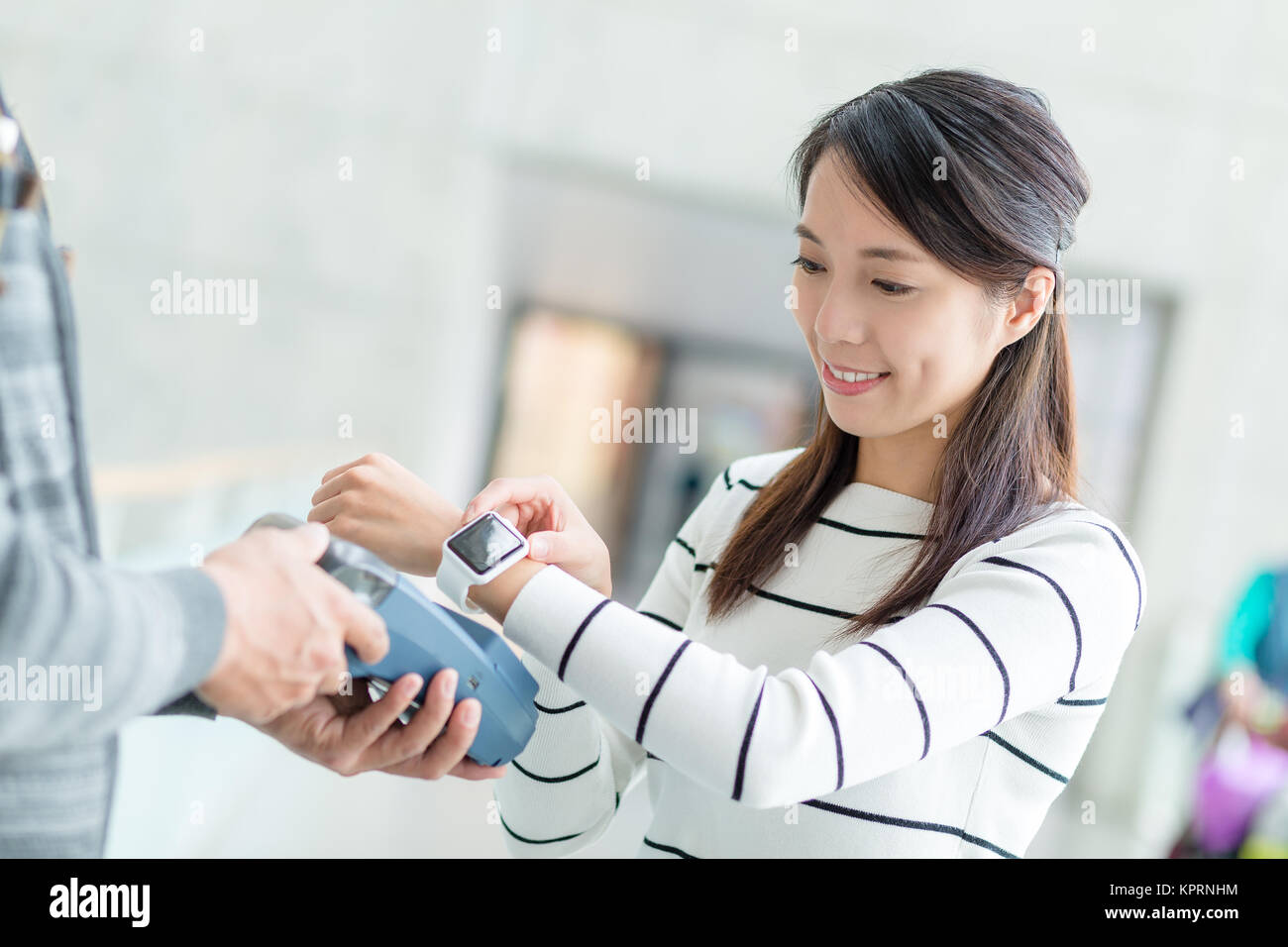 Woman using NFC payment with smart watch Stock Photo - Alamy