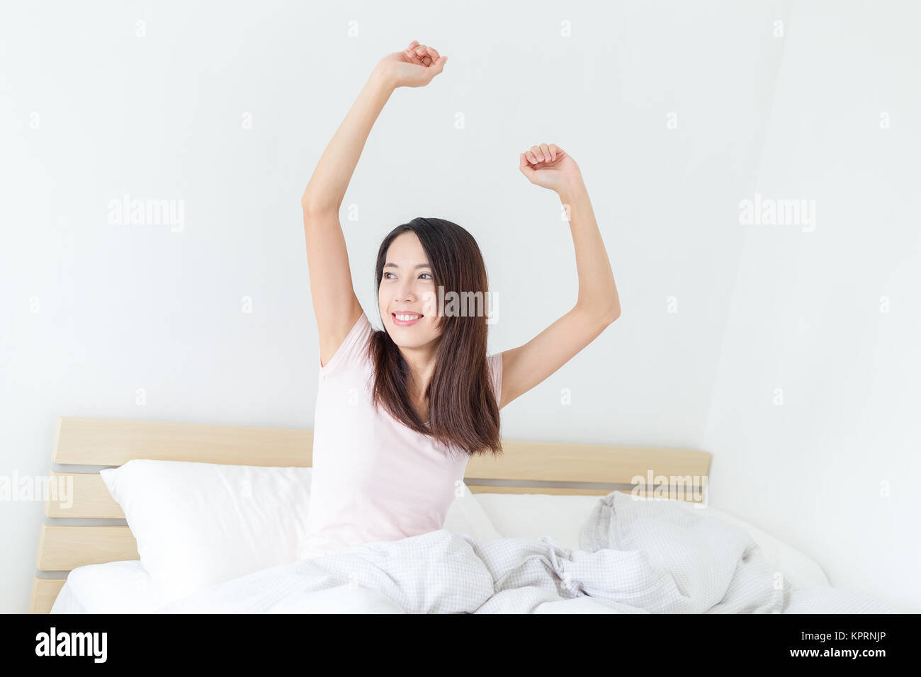 Woman wake up at morning and stretching her hand Stock Photo - Alamy