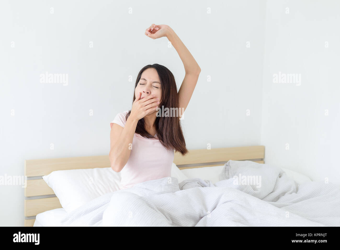 Tired sleepy woman waking up and yawning Stock Photo - Alamy