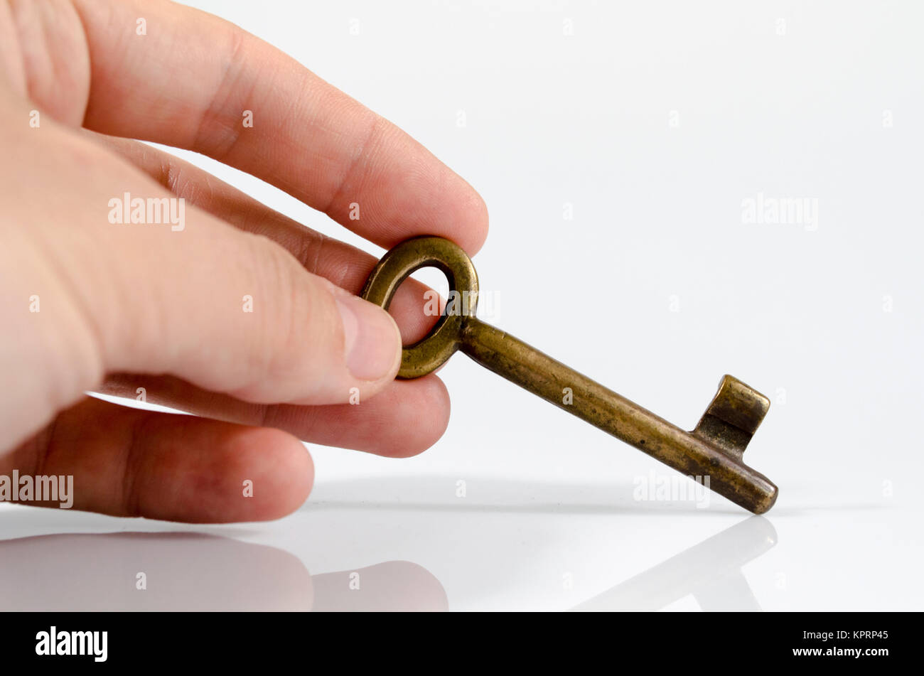 Hand holding key Stock Photo - Alamy