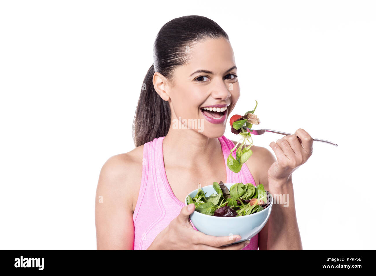 Pretty woman eating green salad Stock Photo - Alamy