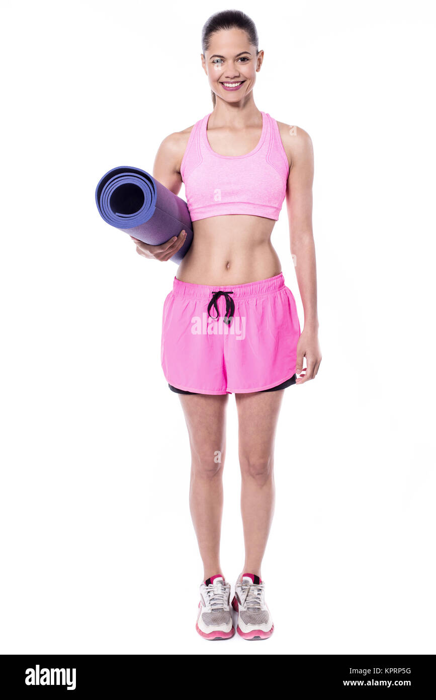 Full length pose of trainer with exercise mat Stock Photo - Alamy